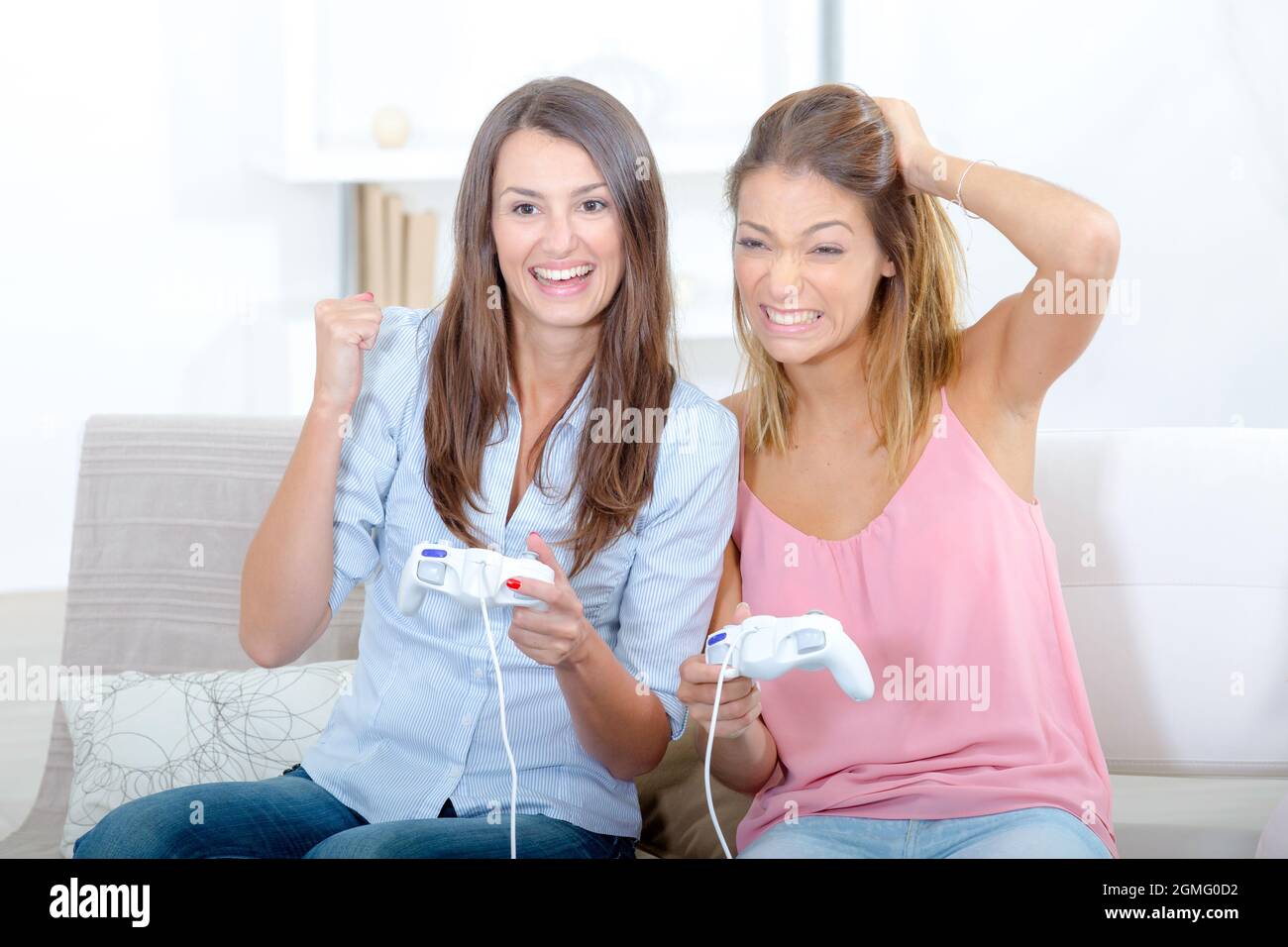 two girls playing video games Stock Photo - Alamy