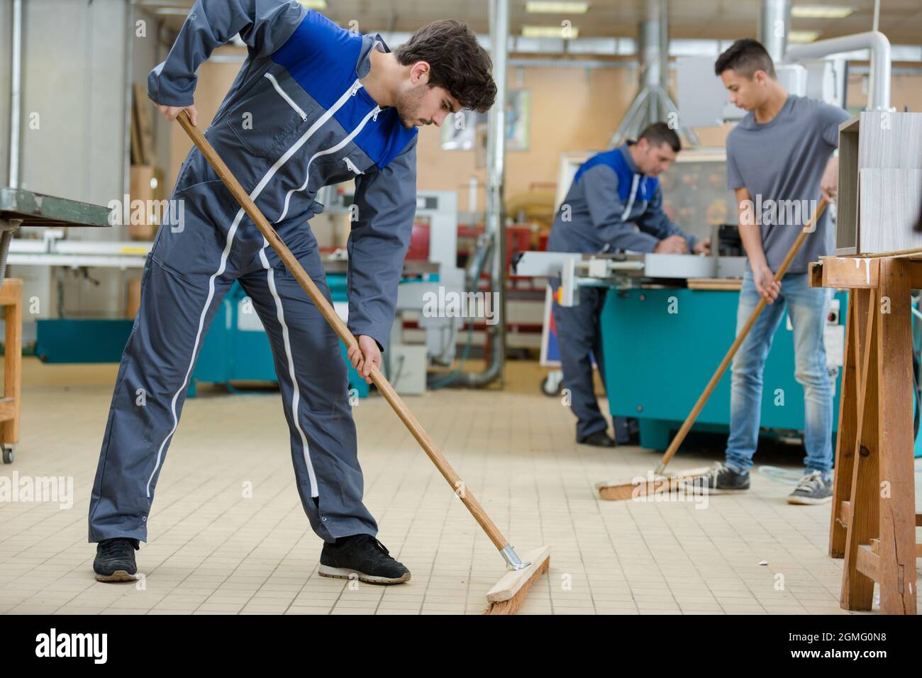 group of workers cleaning factory Stock Photo - Alamy