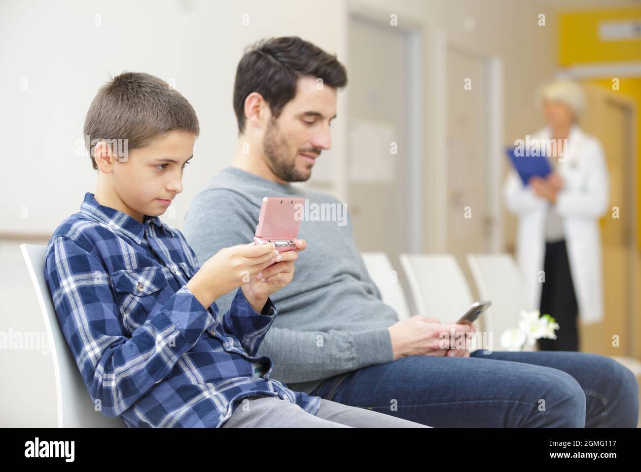 father son waiting in room at clinic Stock Photo - Alamy