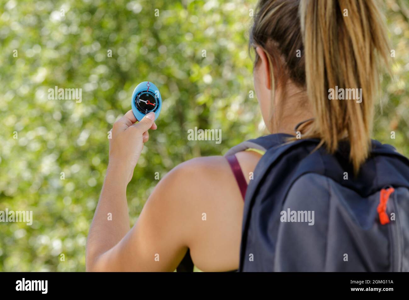 a woman checking digital compass Stock Photo - Alamy