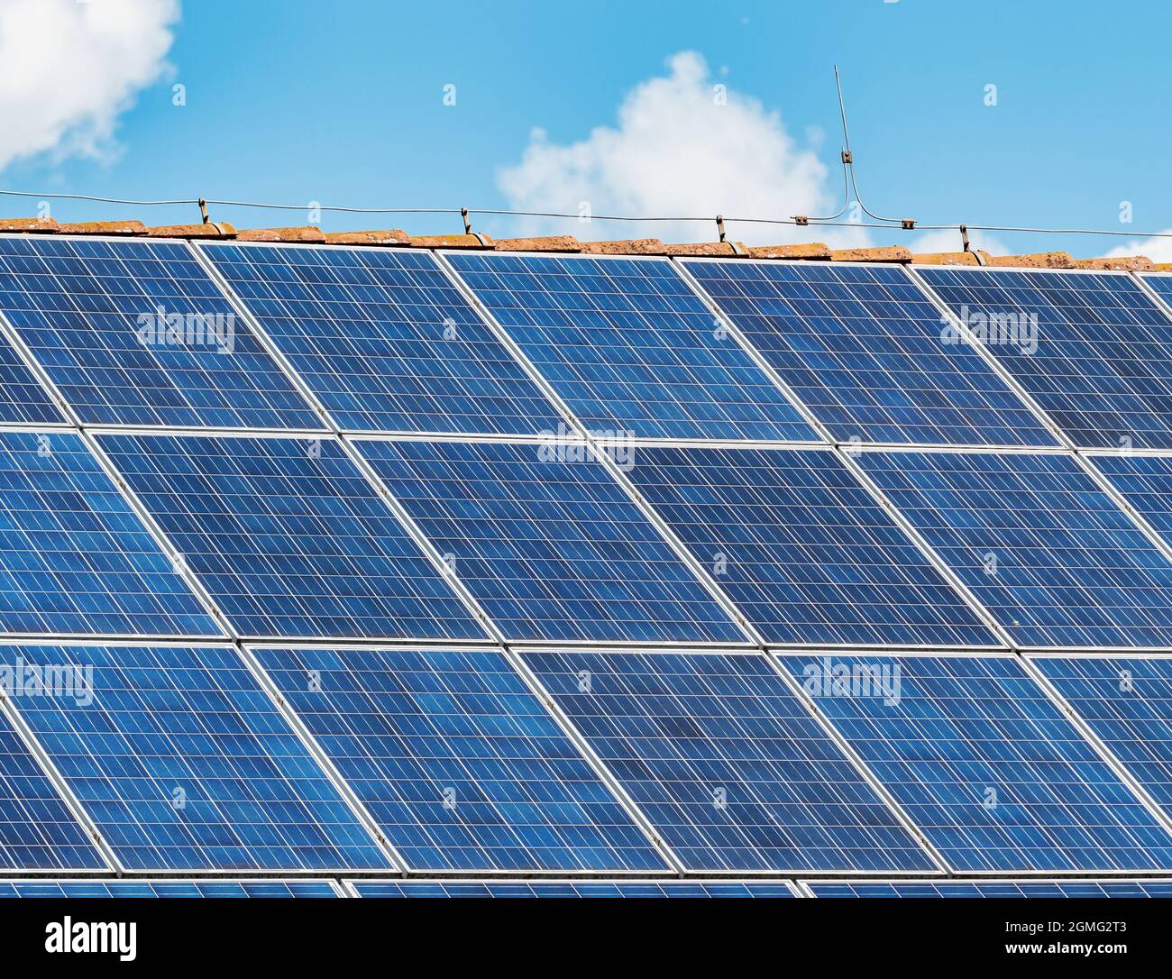 Roof with solar panel reflecting the sun light in the perfect sky with ...