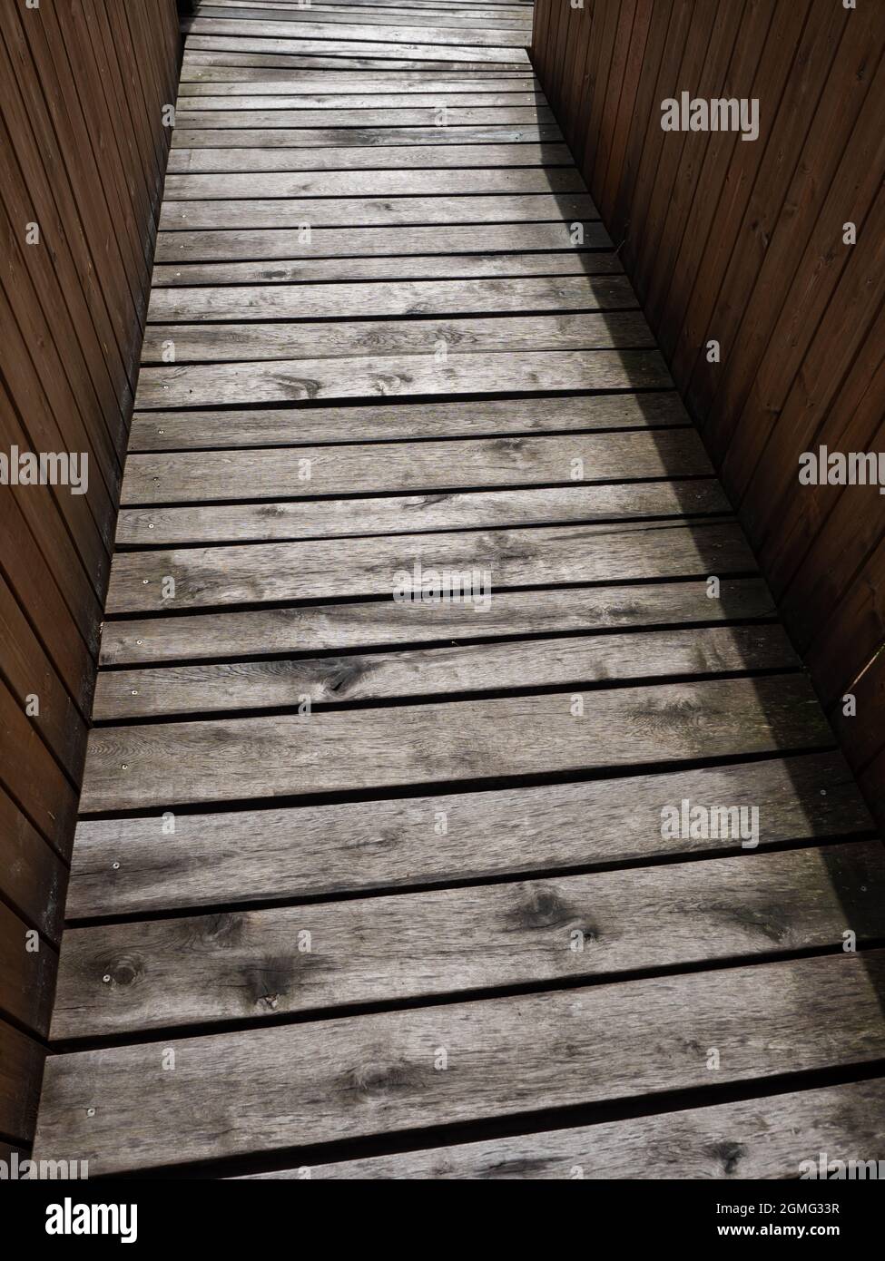 Wet wooden planks of path for wheelchairs, another castle entrance ...