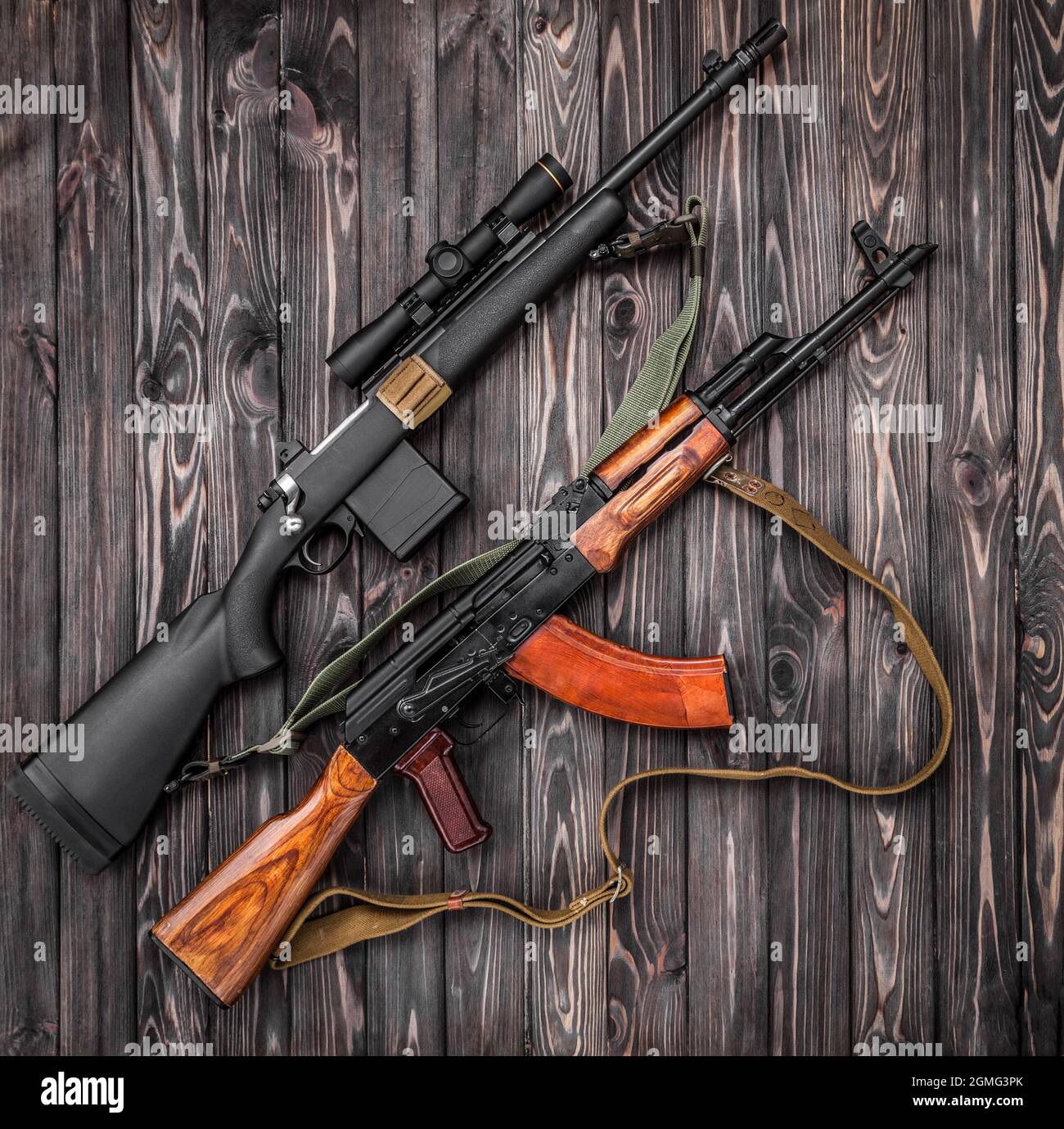 Two weapons lie on a plank surface. An old Soviet automatic carbine and ...
