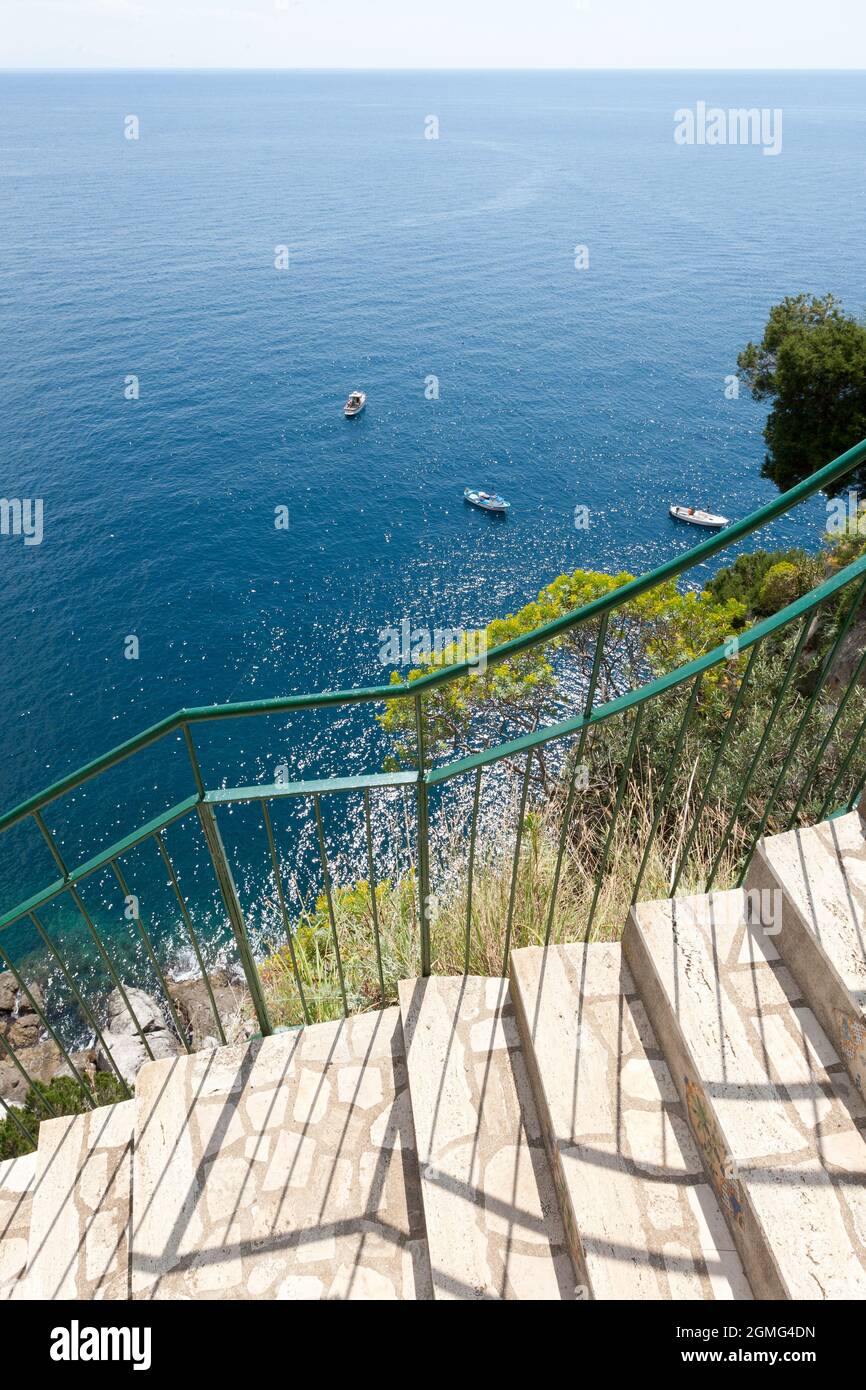 Stone stairs lead from the hilltop to the sea in Praiano, Italy on the ...