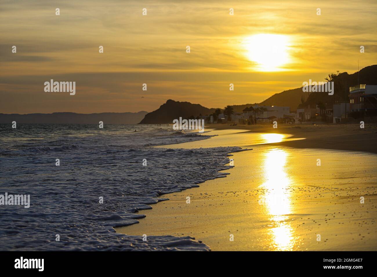 Sand and ocean water waves on the Bahia de Kino beach at sunset in ...