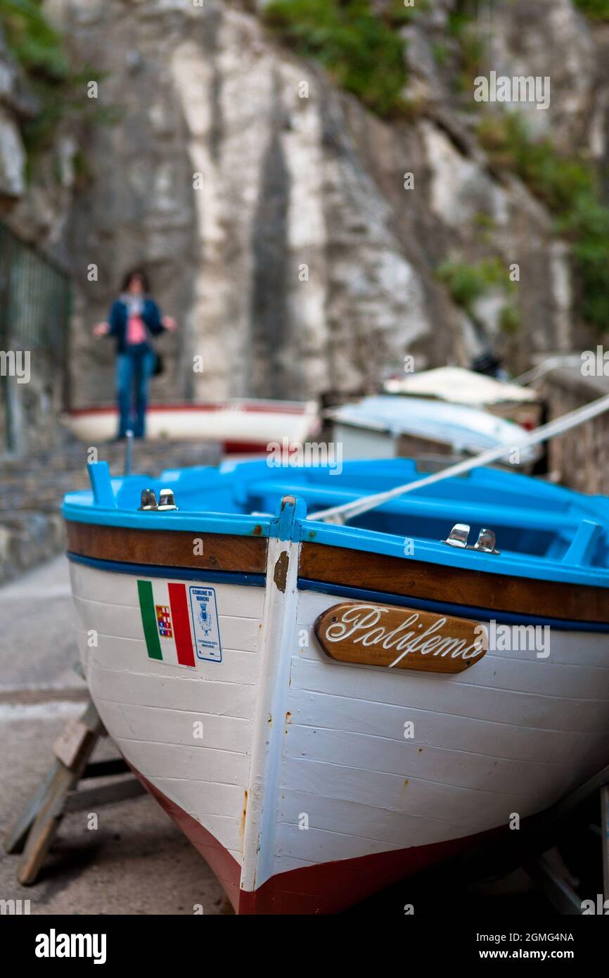 A small Italian vintage boat sits on the stone docks of Praiano Stock ...