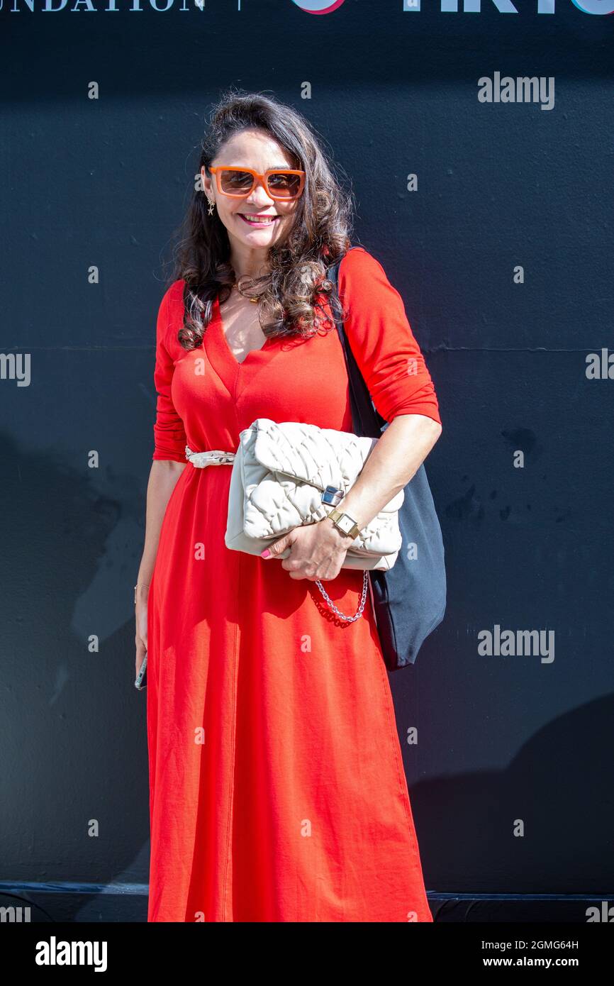 Lady in a red dress attends the London Fashion Week. (Photo by Pietro ...