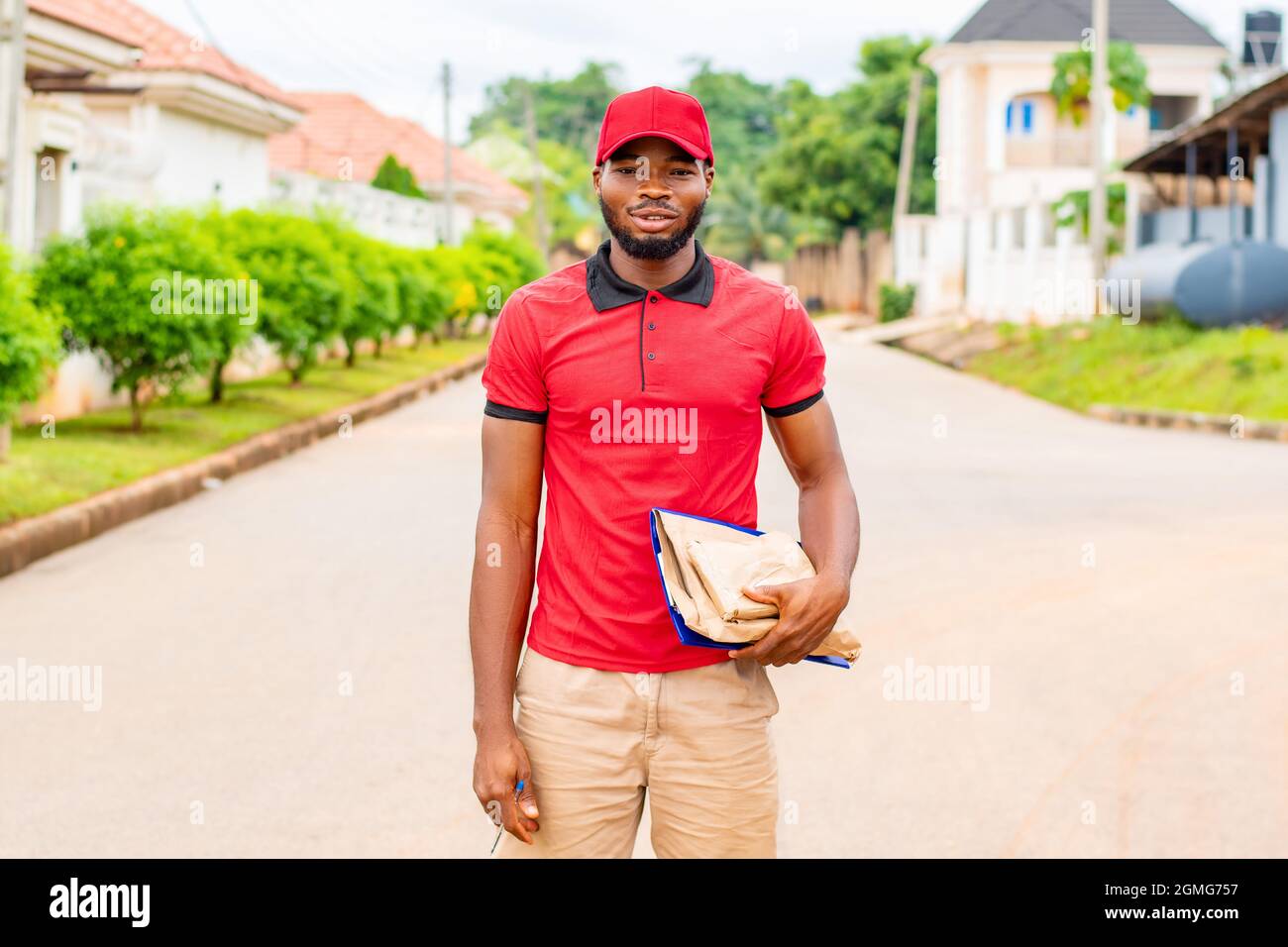 African delivery man carrying parcel hi-res stock photography and ...