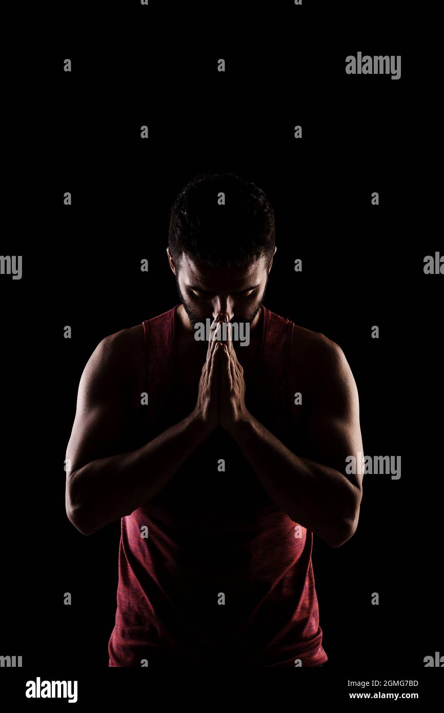 Side lit muscular Caucasian man silhouette. Athlete in red shirt ...