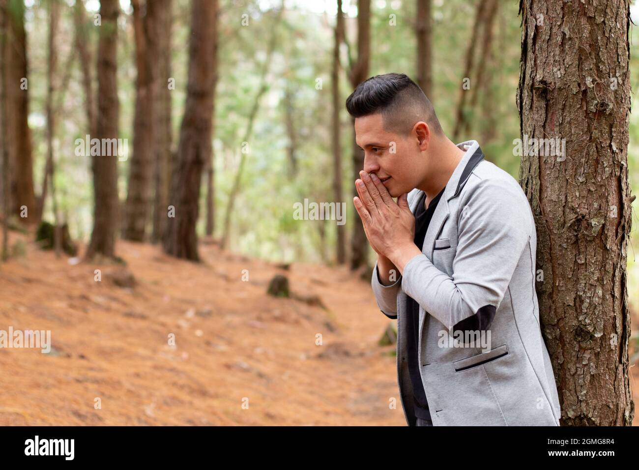 Thoughtful man clasping his hands together near his mouth Stock Photo ...