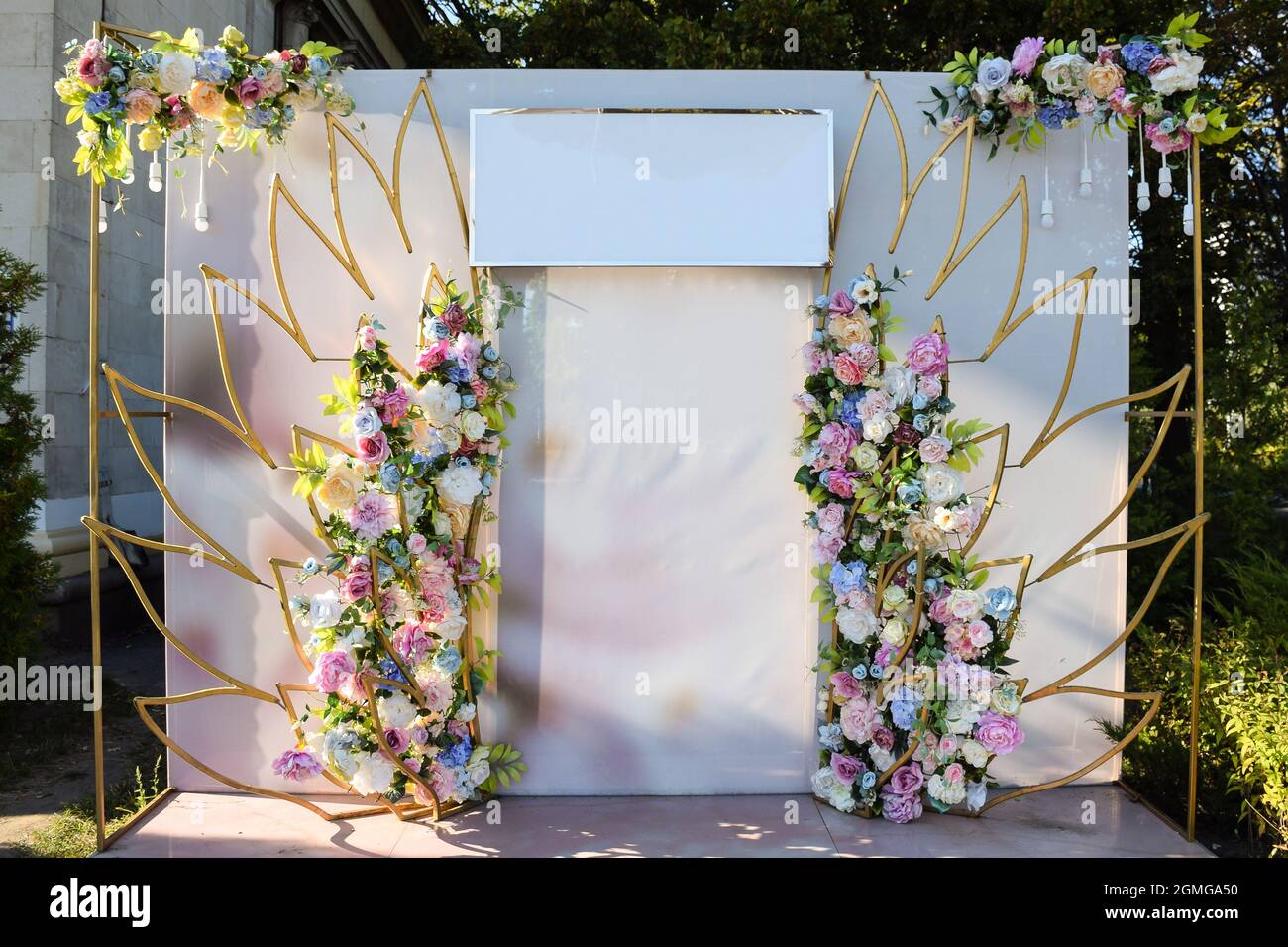 Floral festive wedding arch with blank signboard for congratulation ...