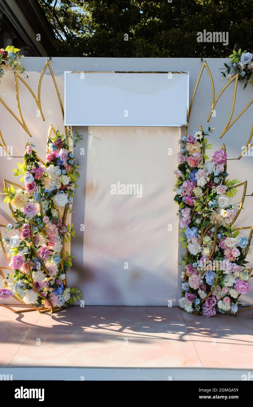 Floral festive wedding arch with blank signboard for congratulation ...
