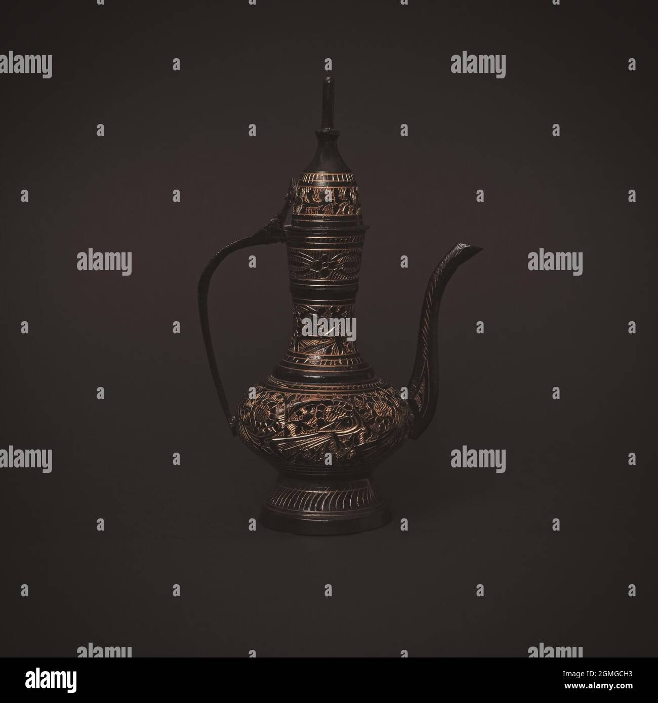 Vintage traditional islamic oriental engraved pitcher handmade on dark ...