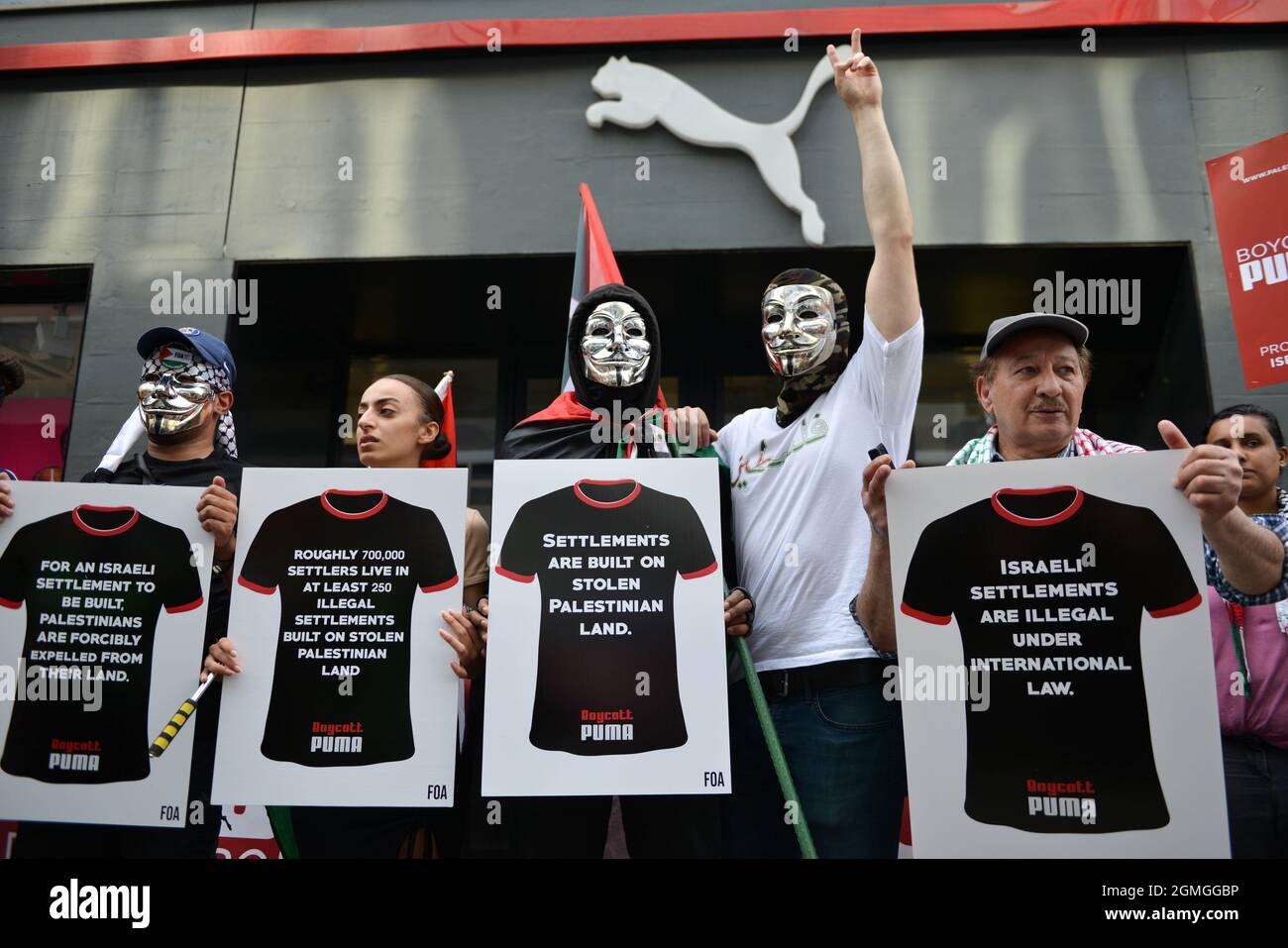 Protesters with banners are taking part in Boycott Puma protest at ...