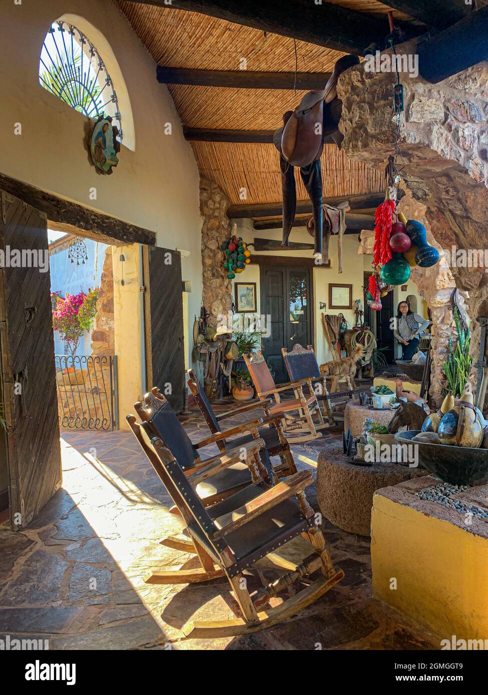 Rustic wood and leather chairs in the garden of the Hacienda del ...