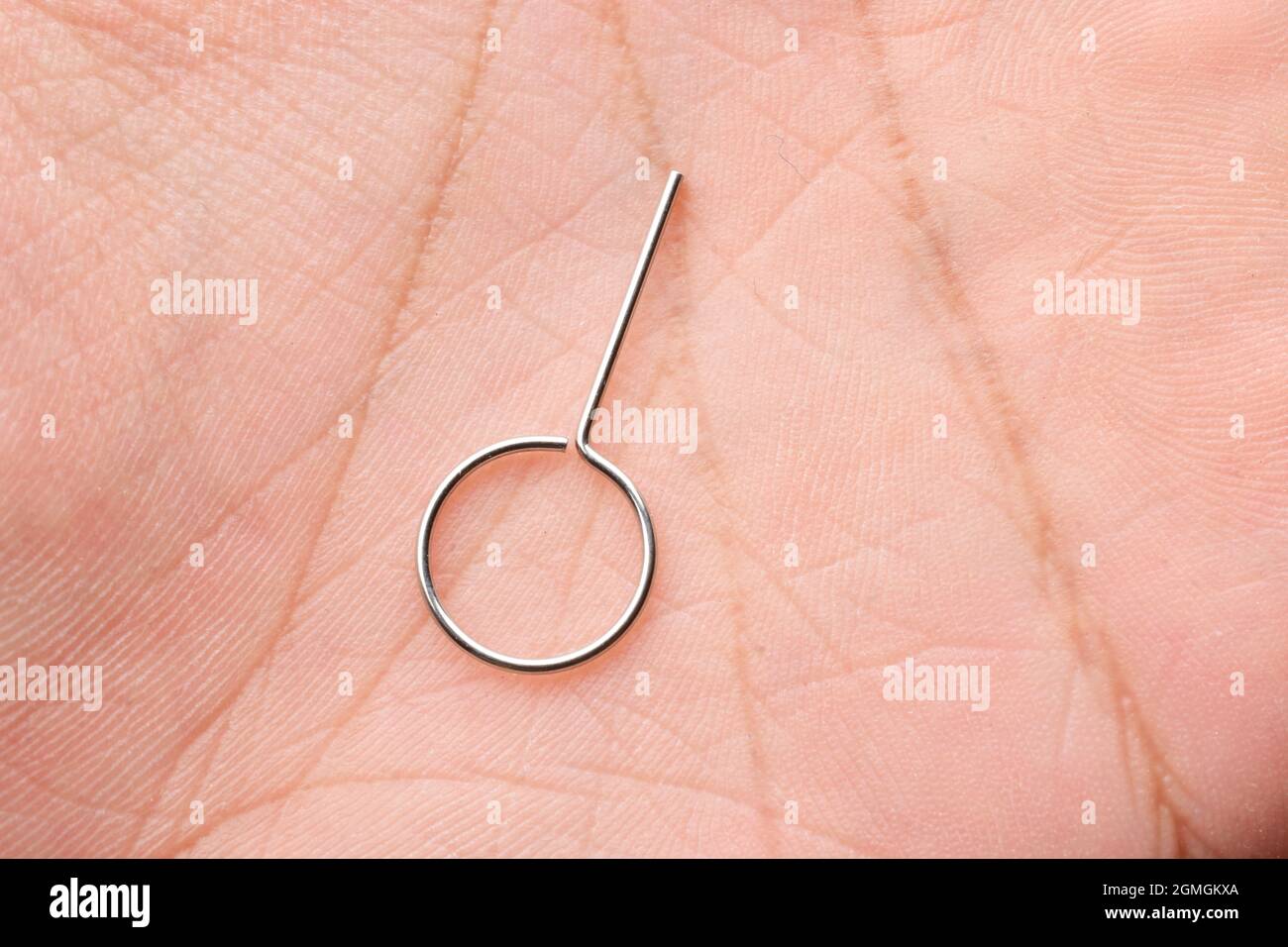 Sim Ejector Tool in Hand Stock Photo - Alamy