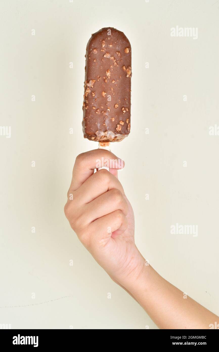 Chocolate Ice Bar In Hand Stock Photo - Alamy