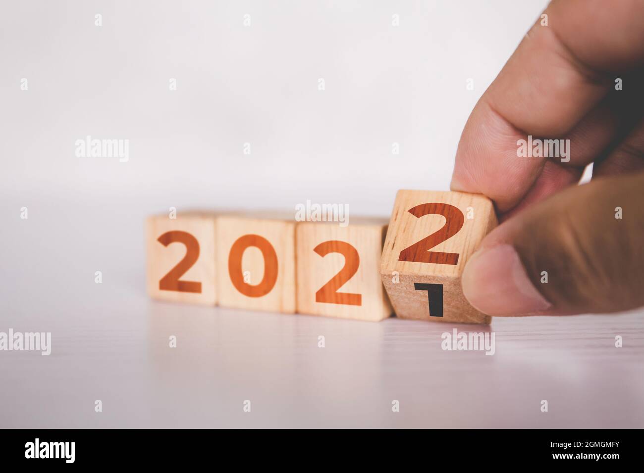 Hands flipping cube wooden block with text year 2022, beginning and ...
