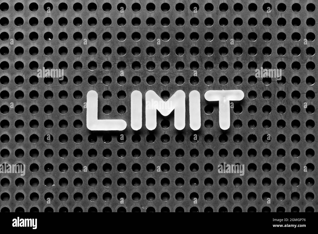 White alphabet letter in word limit on black pegboard background Stock ...