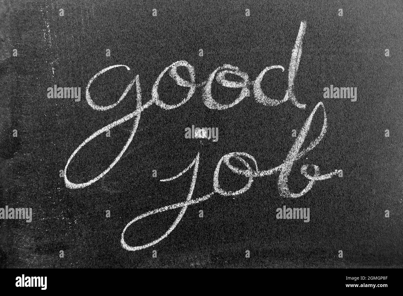 White color chalk hand writing in word good job on black board ...