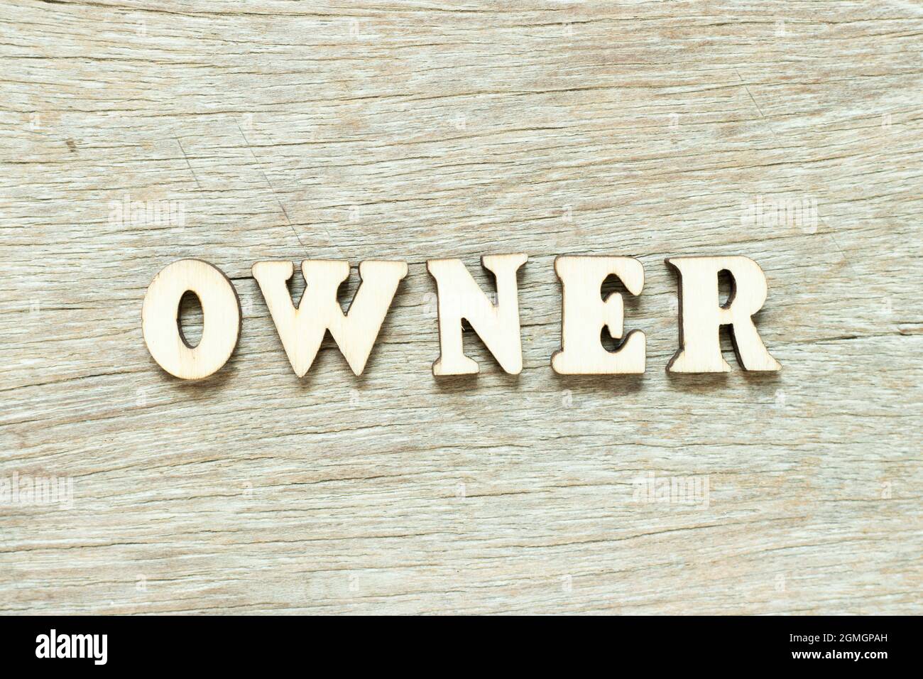 Alphabet letter in word owner on wood background Stock Photo - Alamy