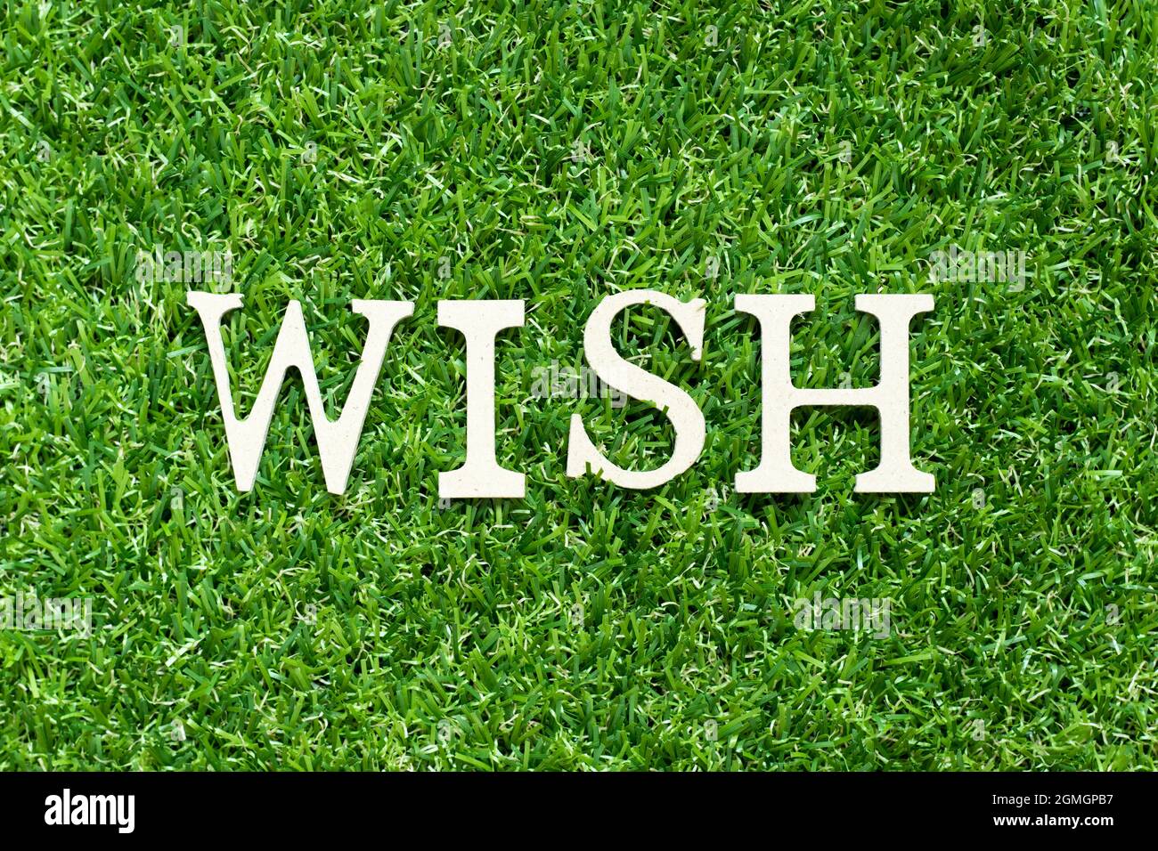 Alphabet letter in word wish on green grass background Stock Photo - Alamy