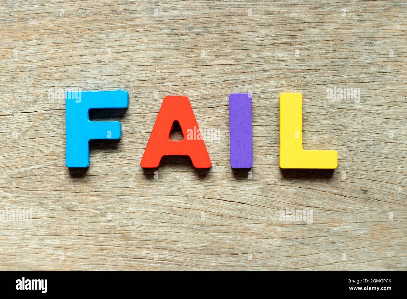Color alphabet letter in word fail on wood background Stock Photo - Alamy