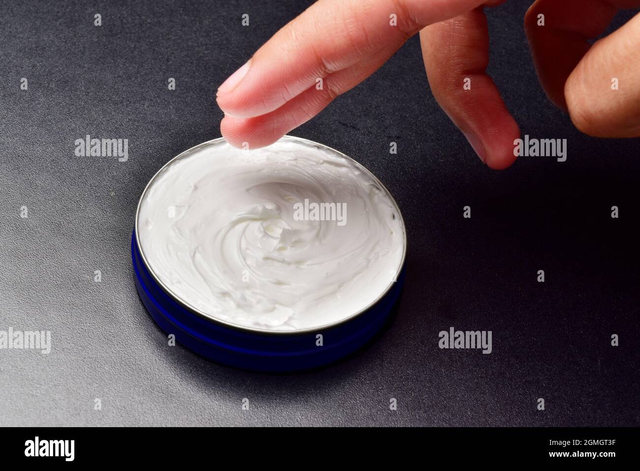 taking cream from container Stock Photo - Alamy