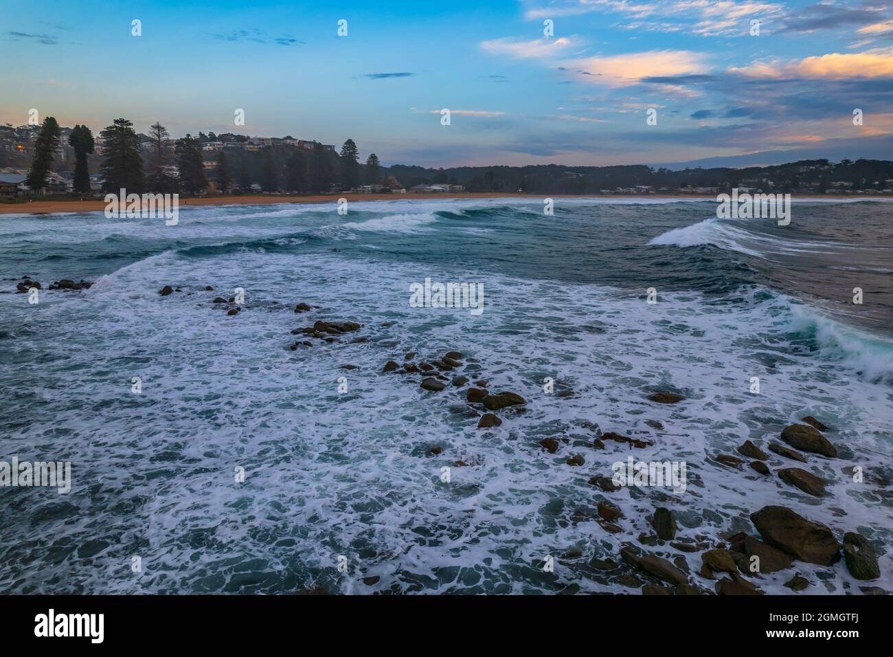 Sunrise seascape with waves and clouds at Avoca Beach on the Central ...