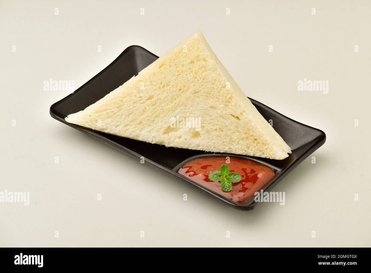 Triangle sandwich with tomato sauce isolated on white background Stock ...