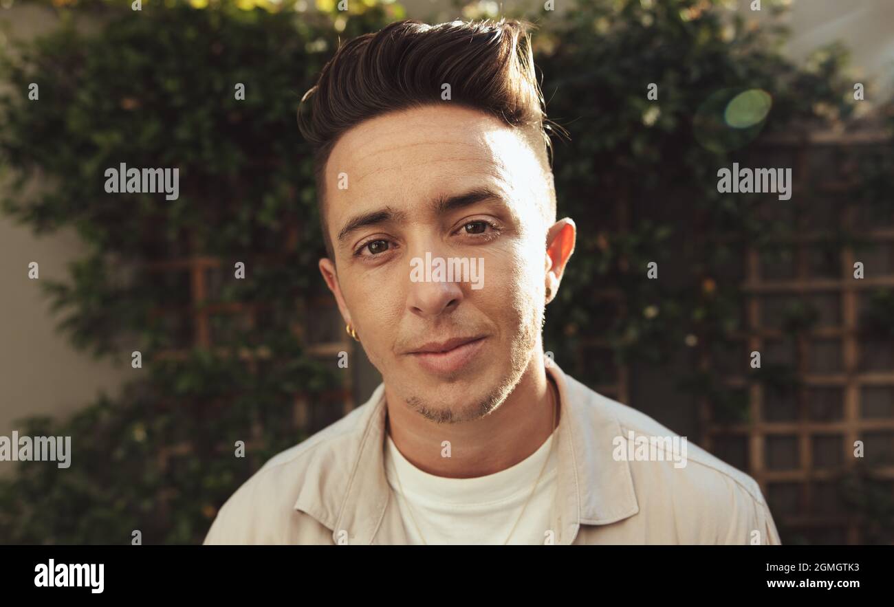 Portrait of a confident transman. Young transgender man looking at the ...