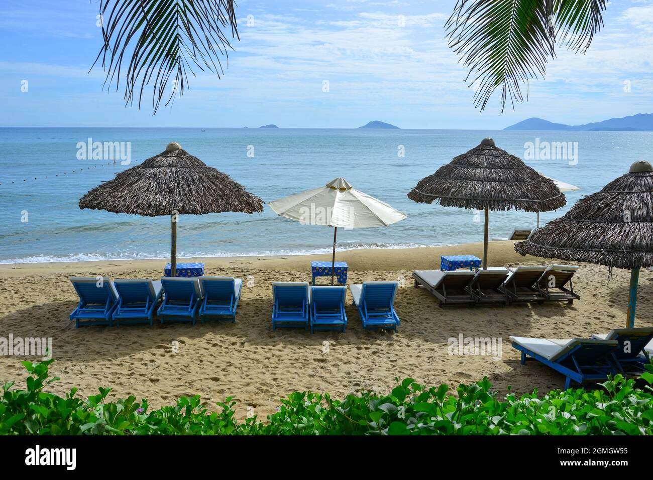 Beautiful Cua Dai beach with relaxing chairs at sunny day in Hoi An ...