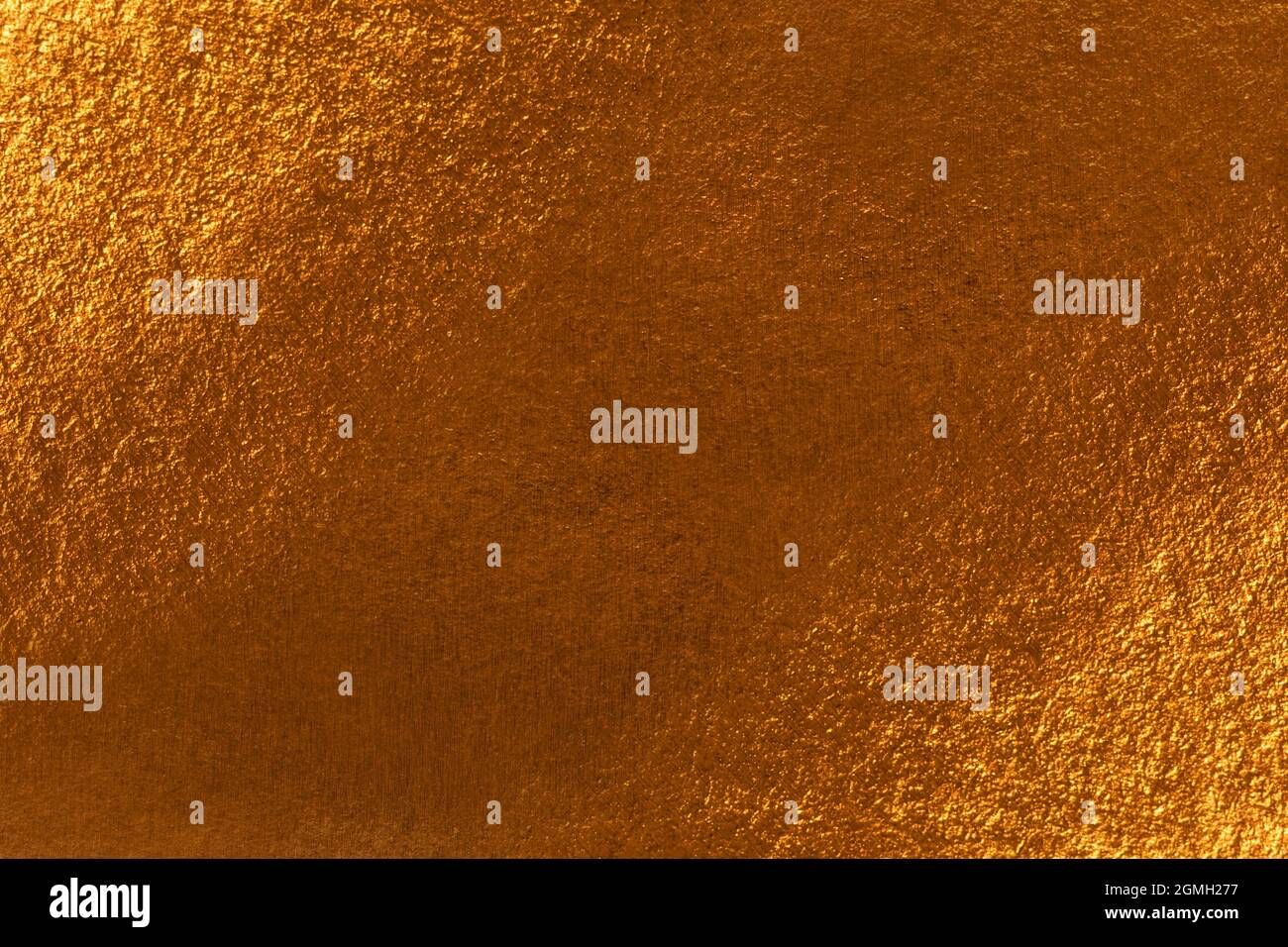 Textured metallic gold background with light and dark highlights ...