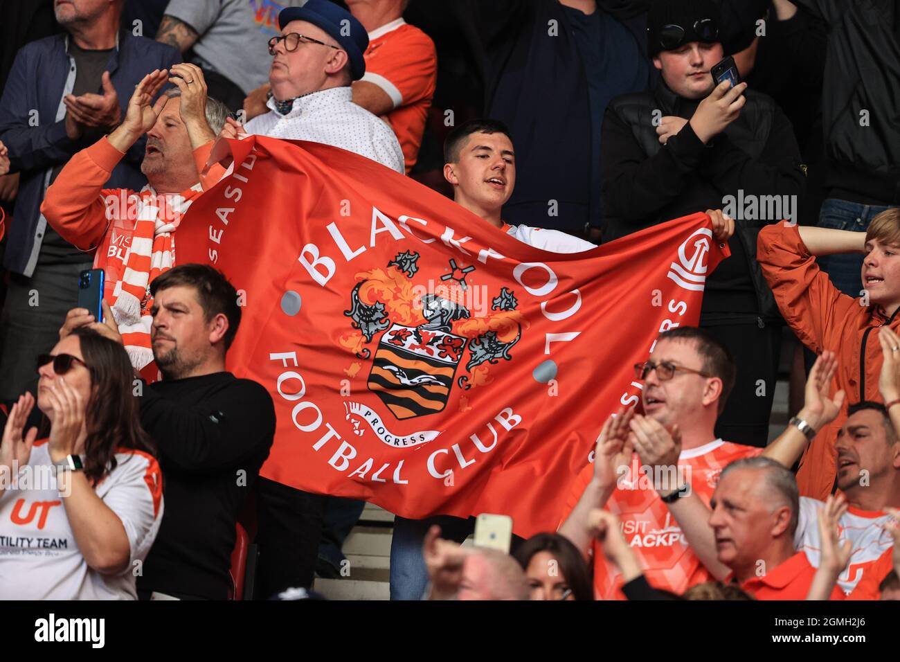 A Blackpool fan sings and waves his flag Stock Photo - Alamy