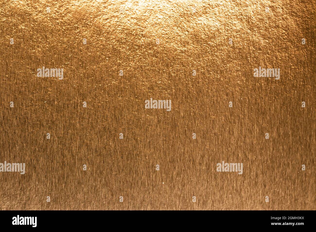 Textured metallic gold background with light and dark highlights ...