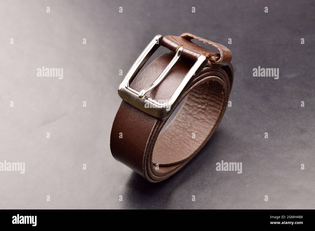 Folded Leather Belt on Dark Background Stock Photo - Alamy