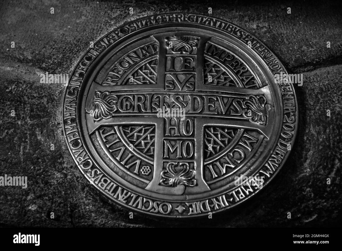 A religious circle and cross symbol with cuts and carvings of ...