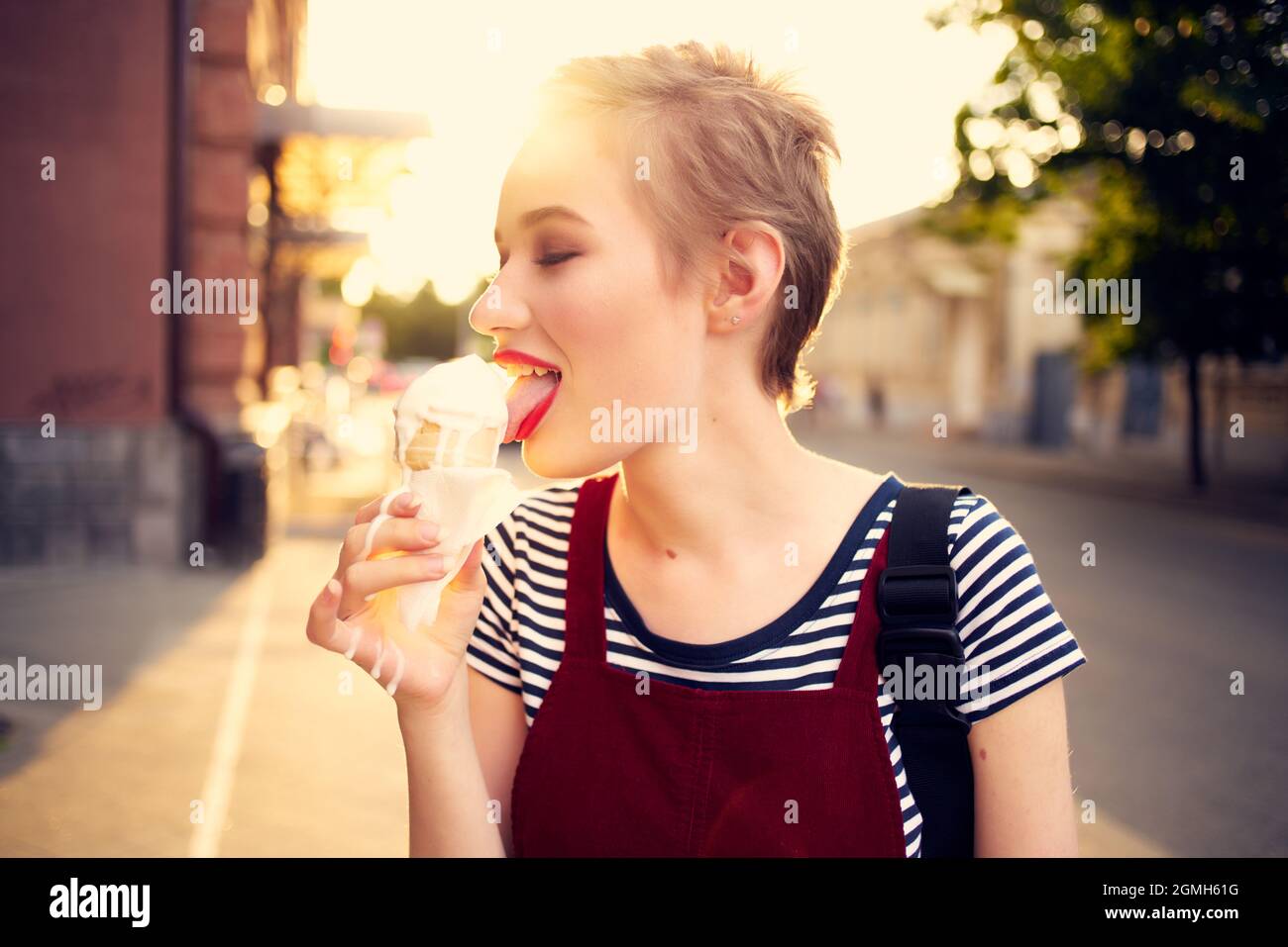 pretty woman outdoors eating ice cream walk Stock Photo - Alamy