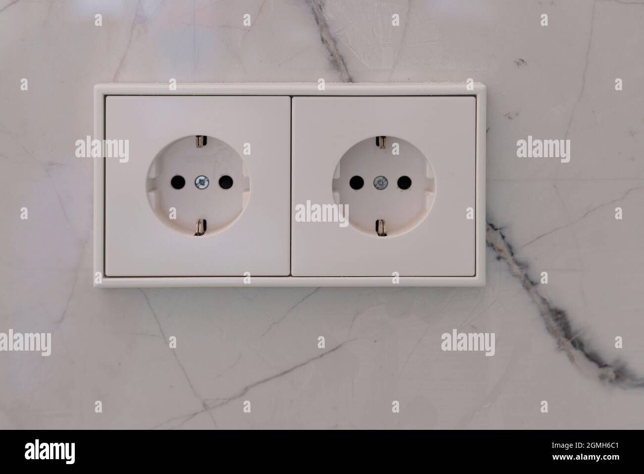 European double socket seen from the front installed over marble Stock ...