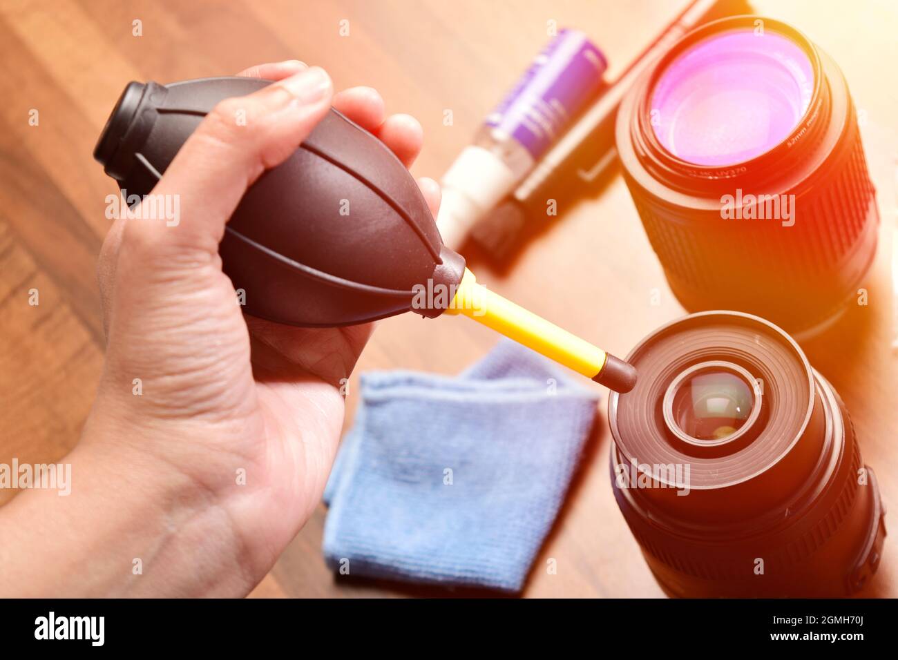 cleaning camera lens from air blower and removing dust particles Stock ...