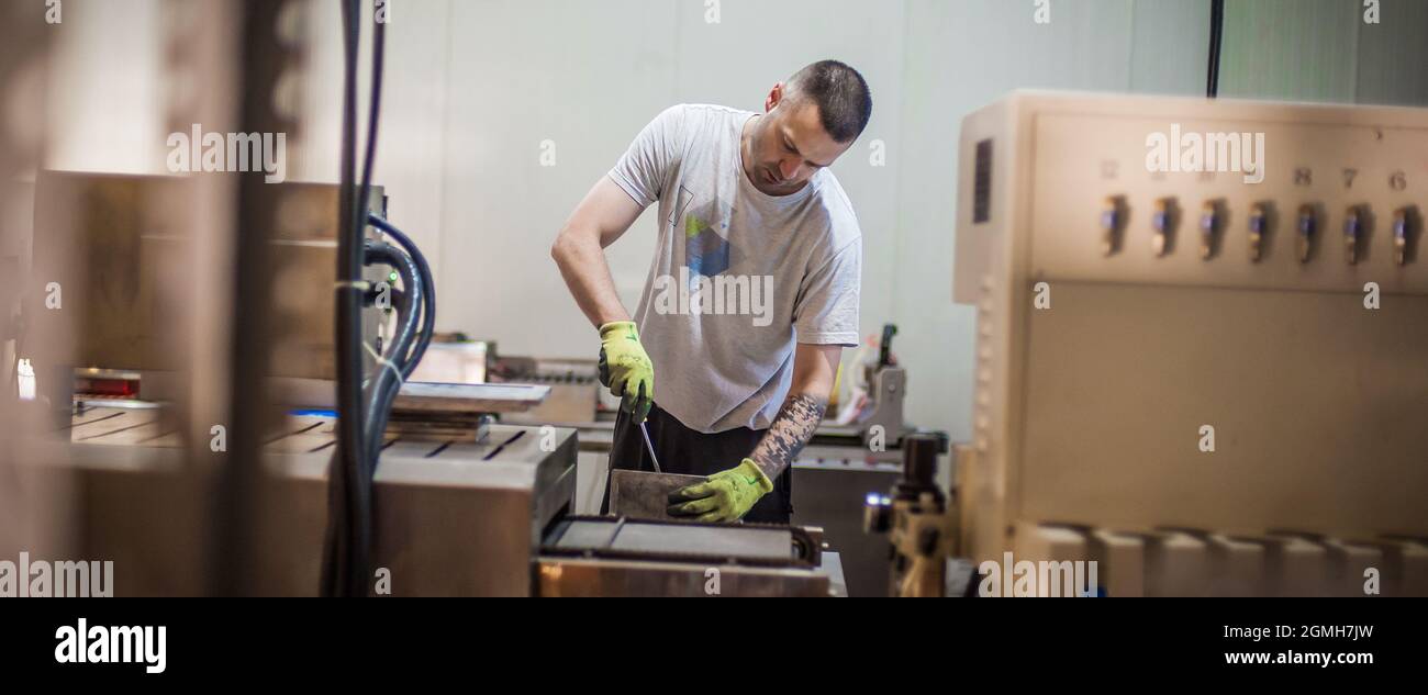 Professional worker technician machinist work in factory production ...