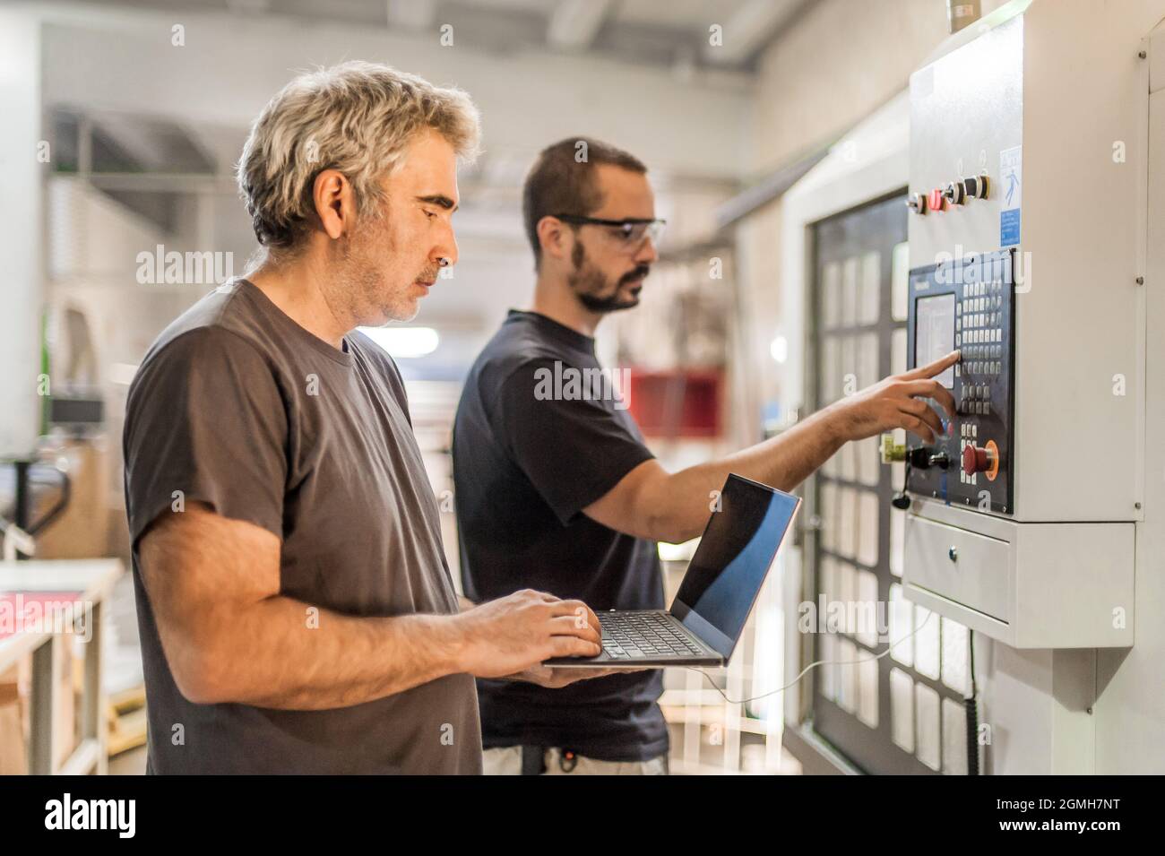 Two field service maintenance engineer technician electrician inspect ...