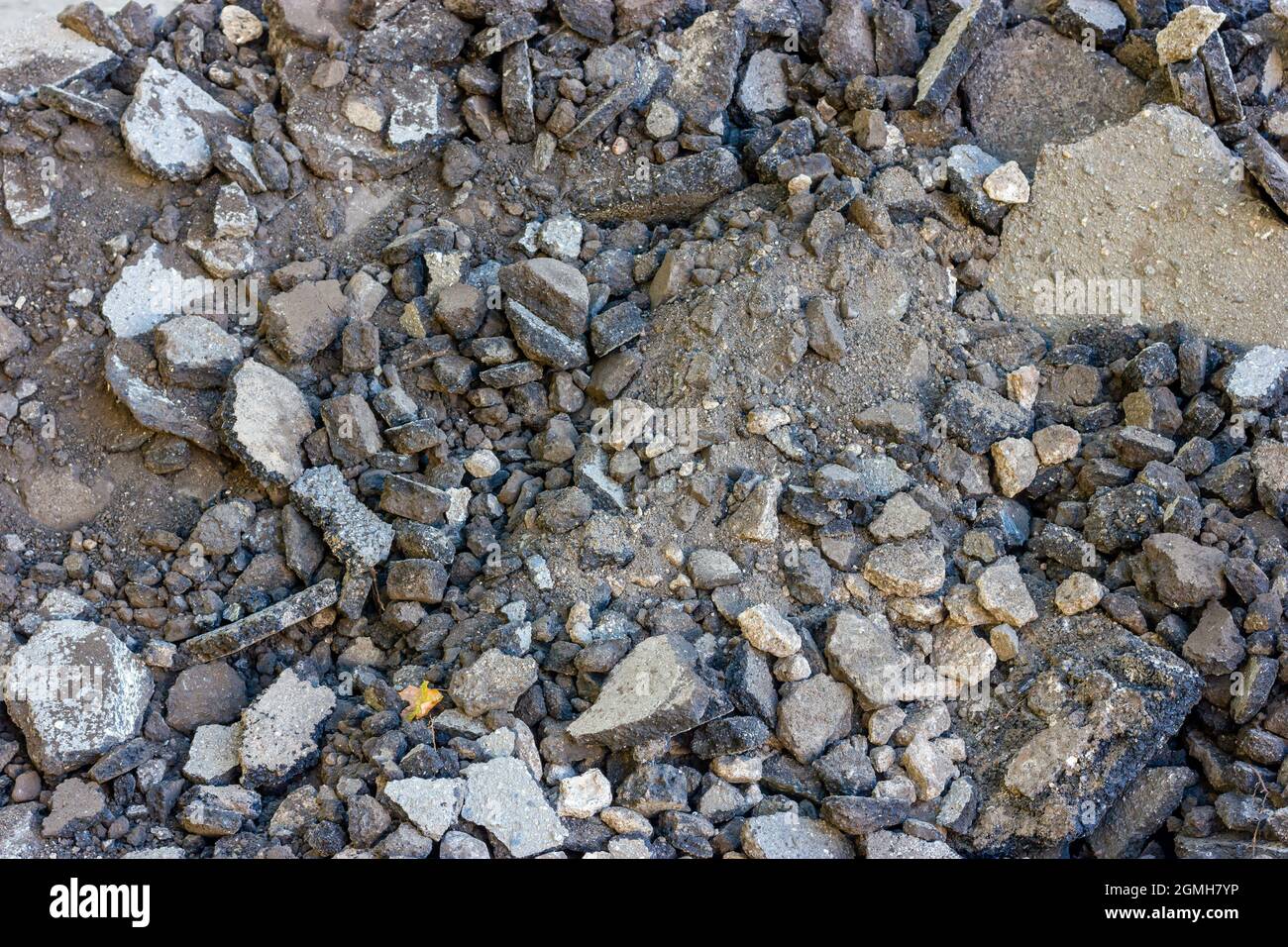 Destroyed asphalt. Broken road surface. Fragments of asphalt pavement ...