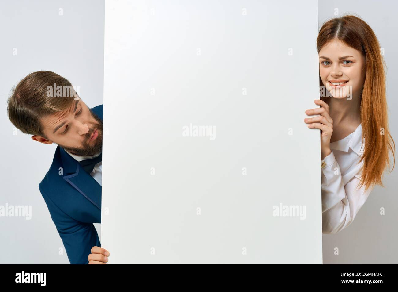 funny man and woman with white mockup poster advertising sign White ...