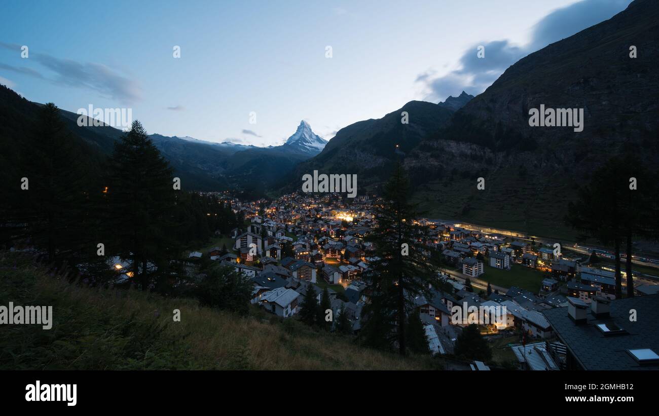 the famous village of zermatt in switzerland in the evening, with the ...
