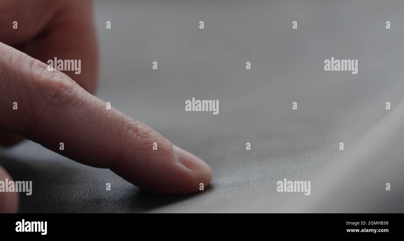 closeup man hand checking soft gray leather clothes, wide photo Stock ...