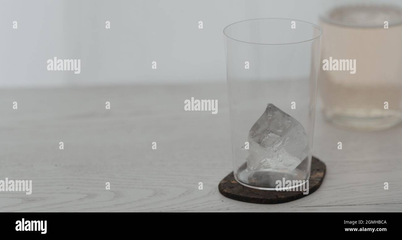 Ice cube falling empty glass hi-res stock photography and images - Alamy