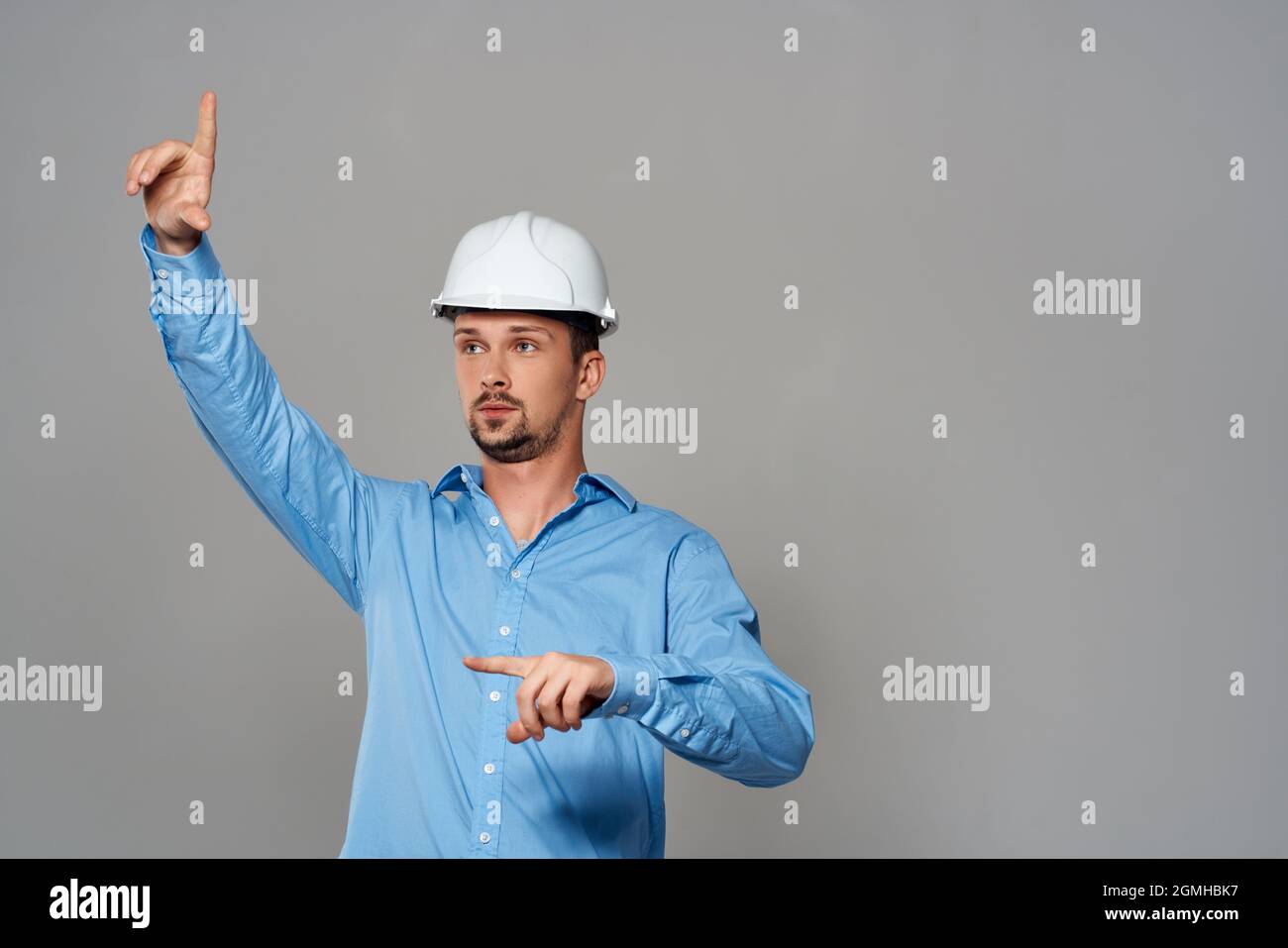 engineer with drawings in hand hand gesture light background Stock ...