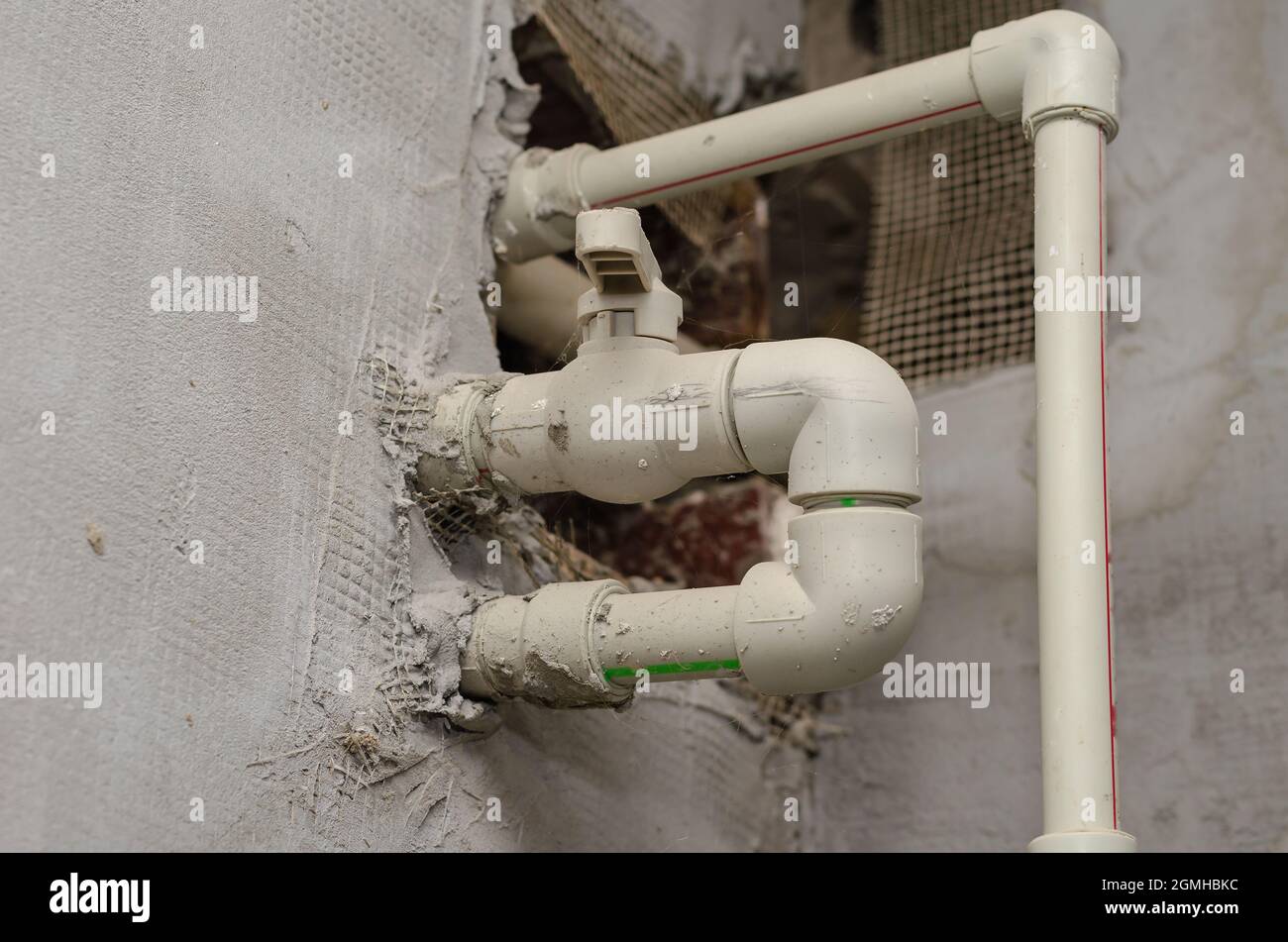 Plastic pipes on the gray wall. Piping with gate valves. Remote Stock ...