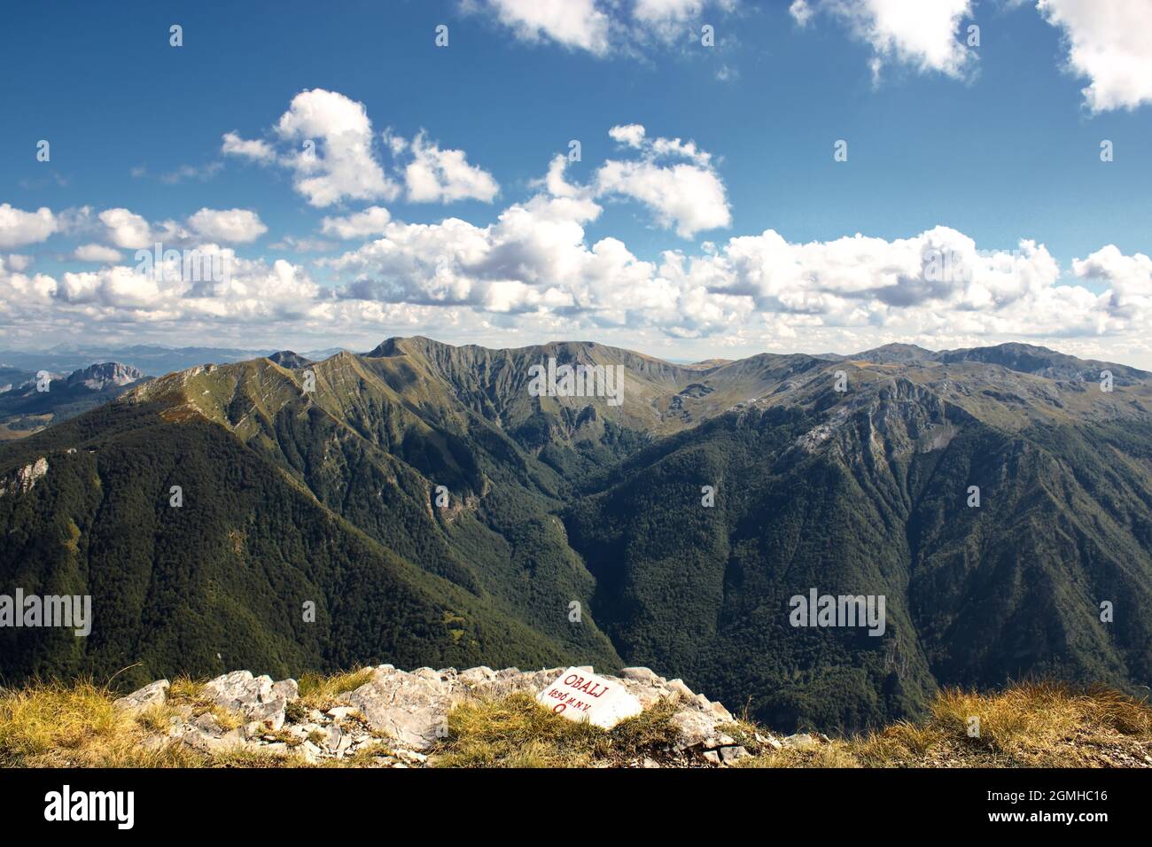 A high angle shot of mountainous landscape with peaks under sunlight ...